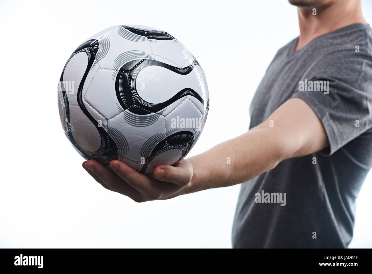 Simple football ball close-up on player hand isolated on white ...