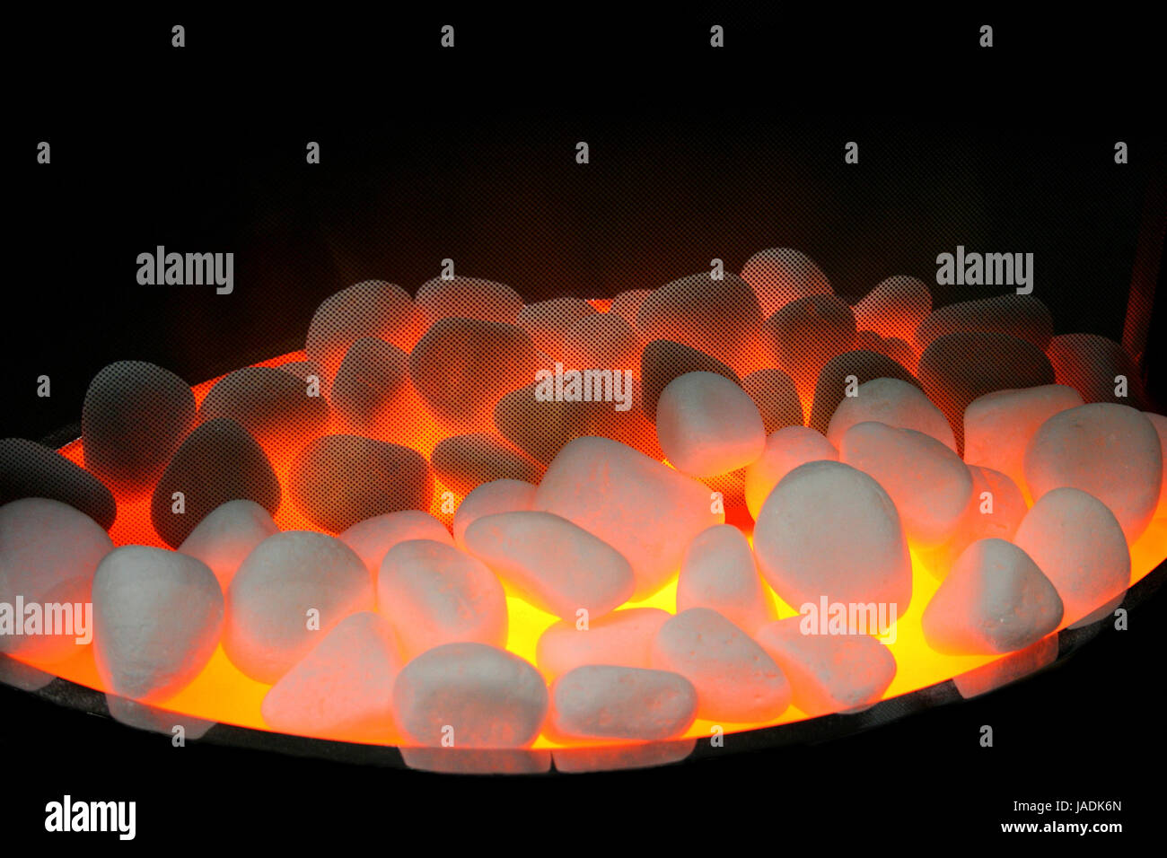 Modern fireplace with white fire stones Stock Photo - Alamy