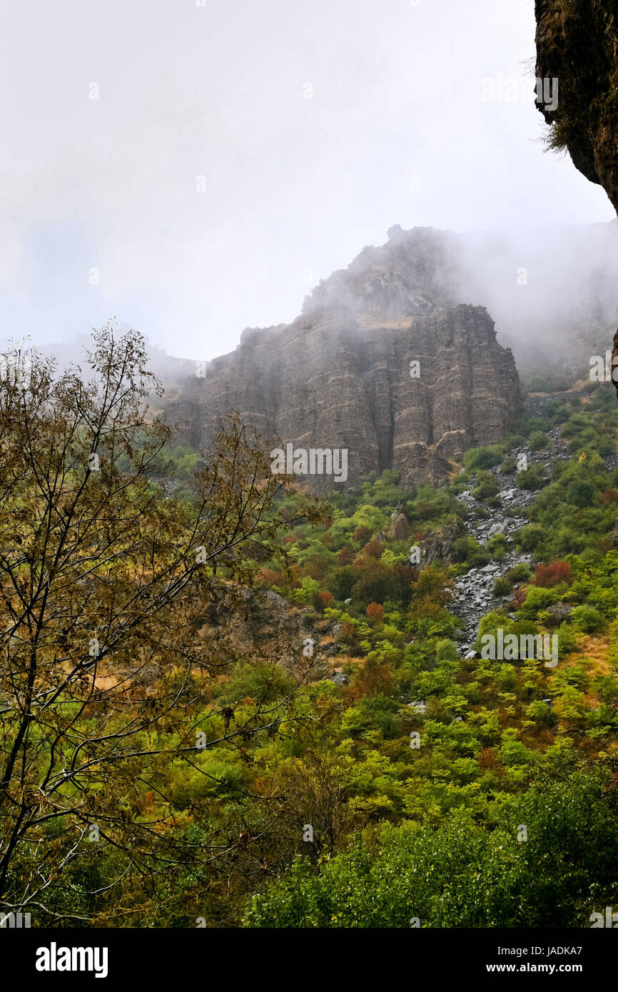 Cliffs in fog cloud in rain in Armenia. Cliffs surrounding Geghard ...