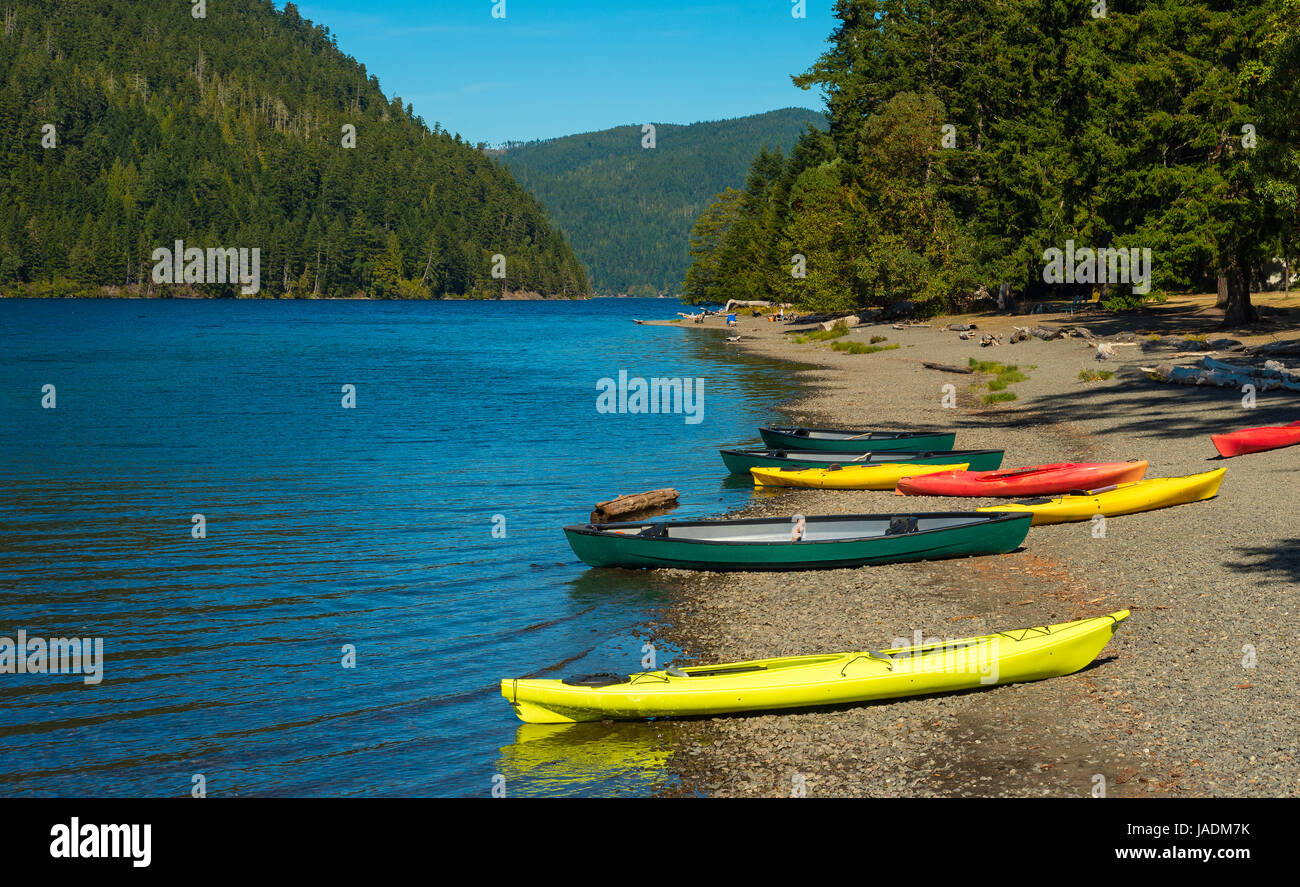 Canoes and kayaks on the beach at Crescent Lake on Washington’s Olympic ...