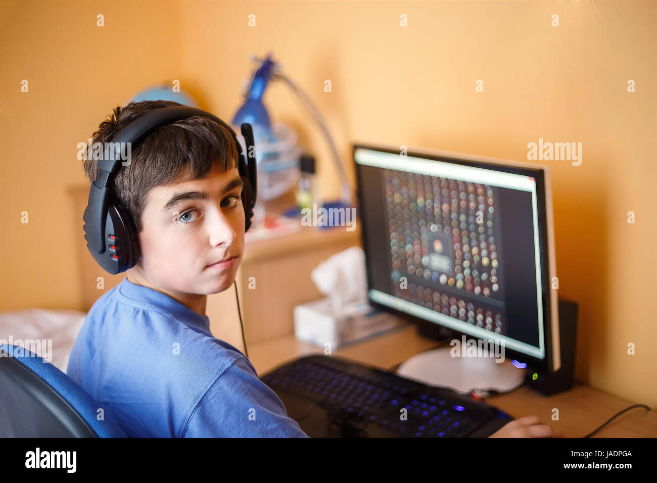 Teenager using computer at home, play game in his child room Stock ...