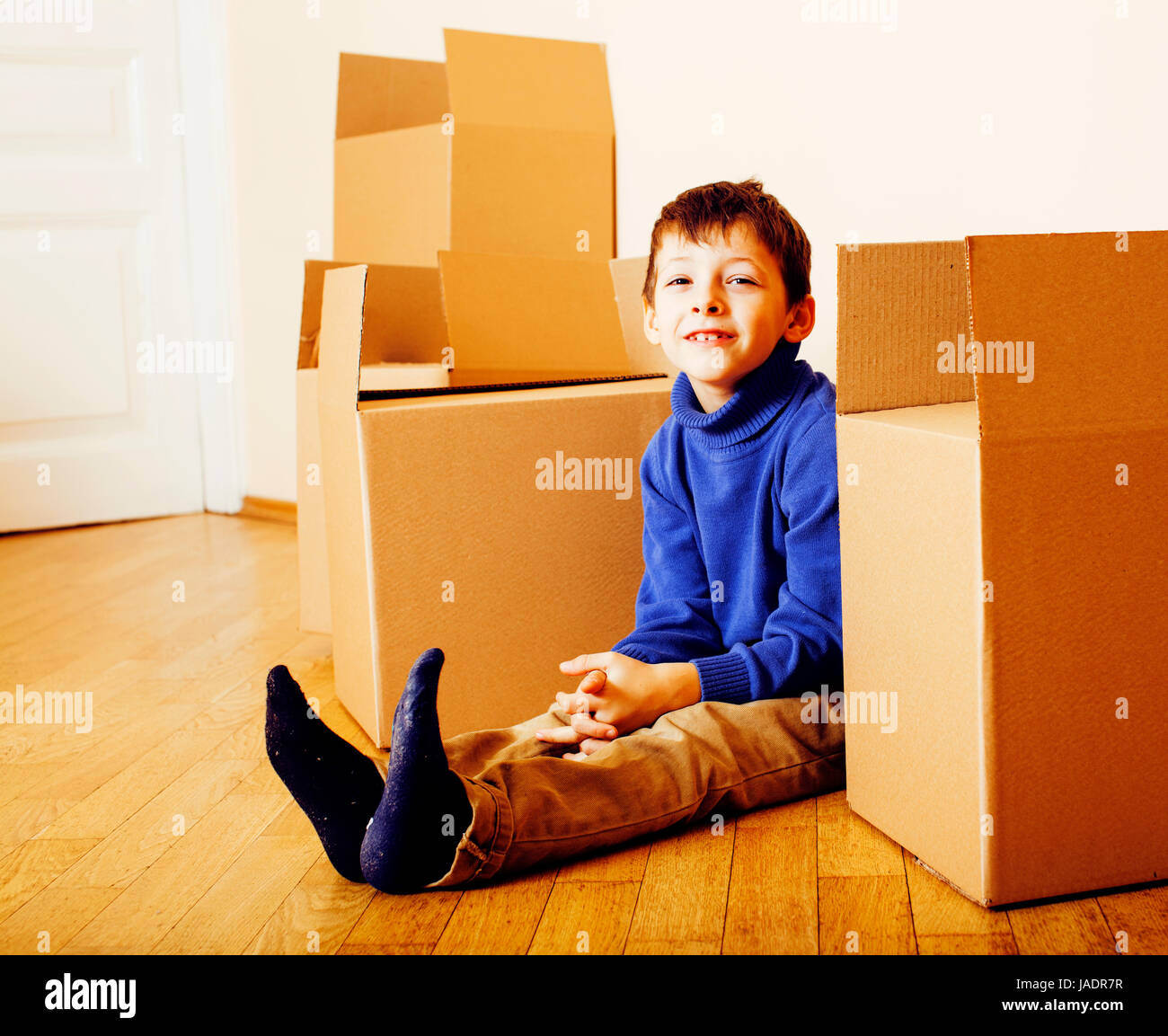 little cute boy in empty room, remoove to new house. home alone emong ...