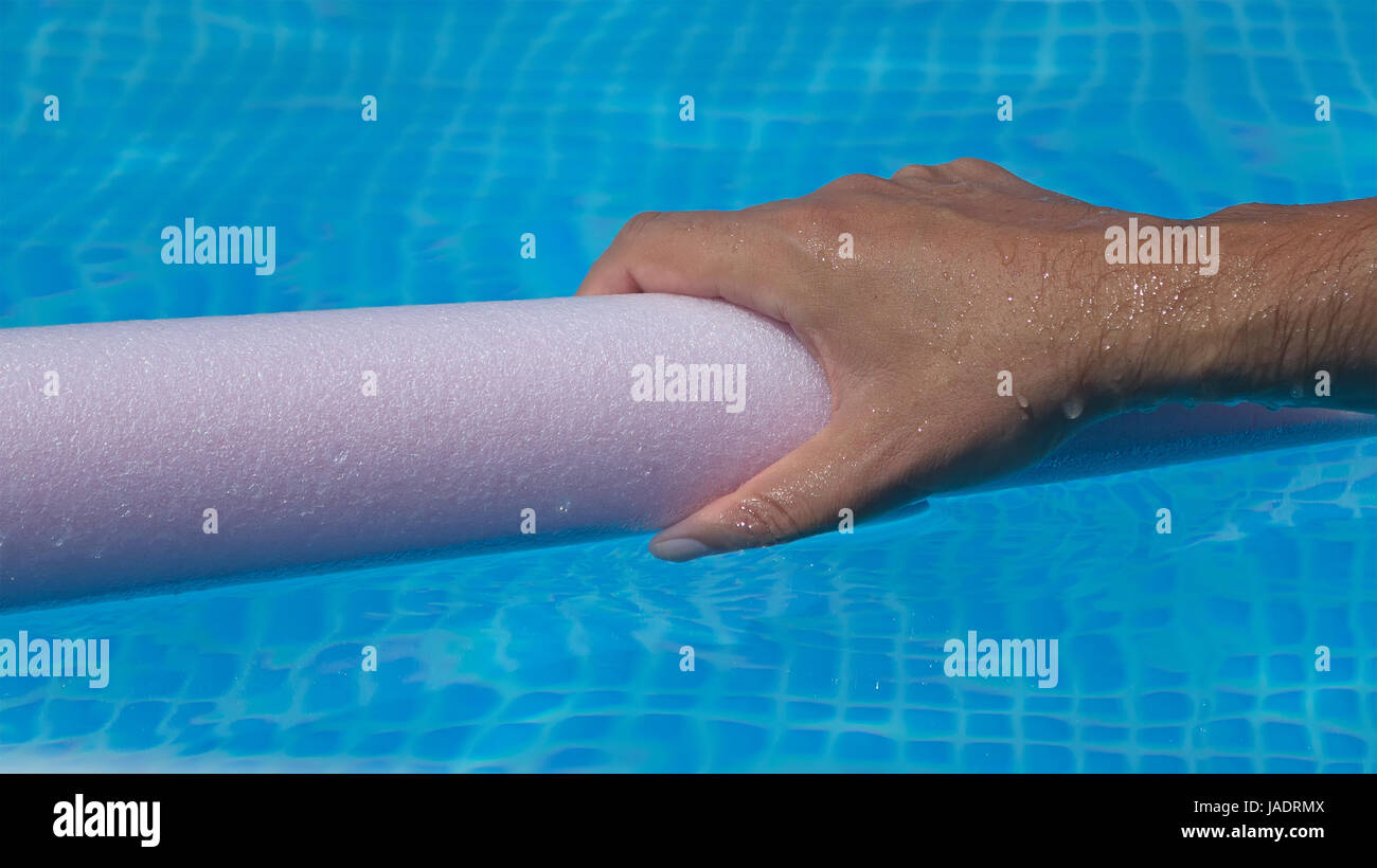wet hand holding a pool noodle Stock Photo - Alamy