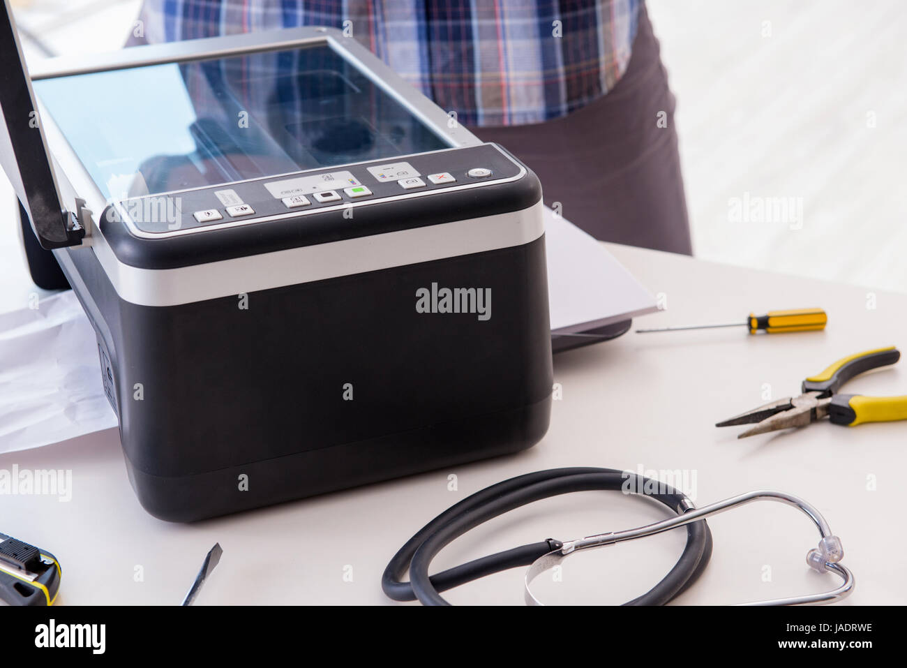Repairman repairing broken color printer Stock Photo - Alamy