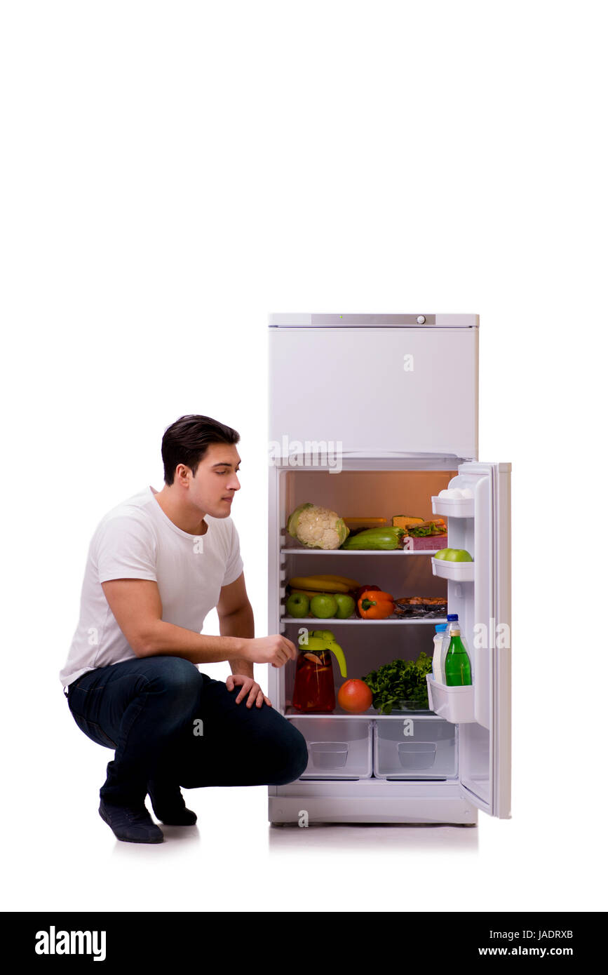 Man next to fridge full of food Stock Photo - Alamy