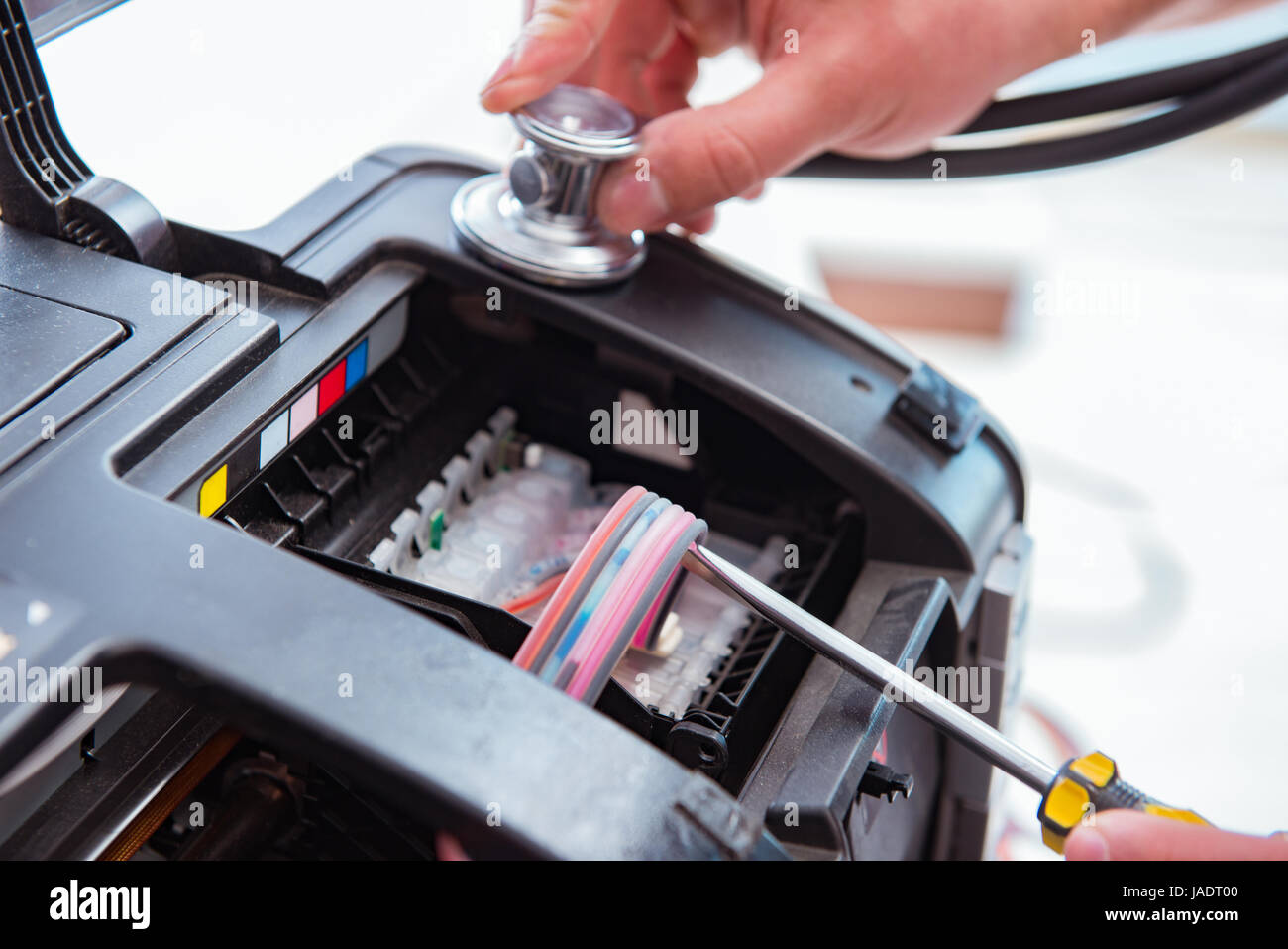 Repairman repairing broken color printer Stock Photo - Alamy