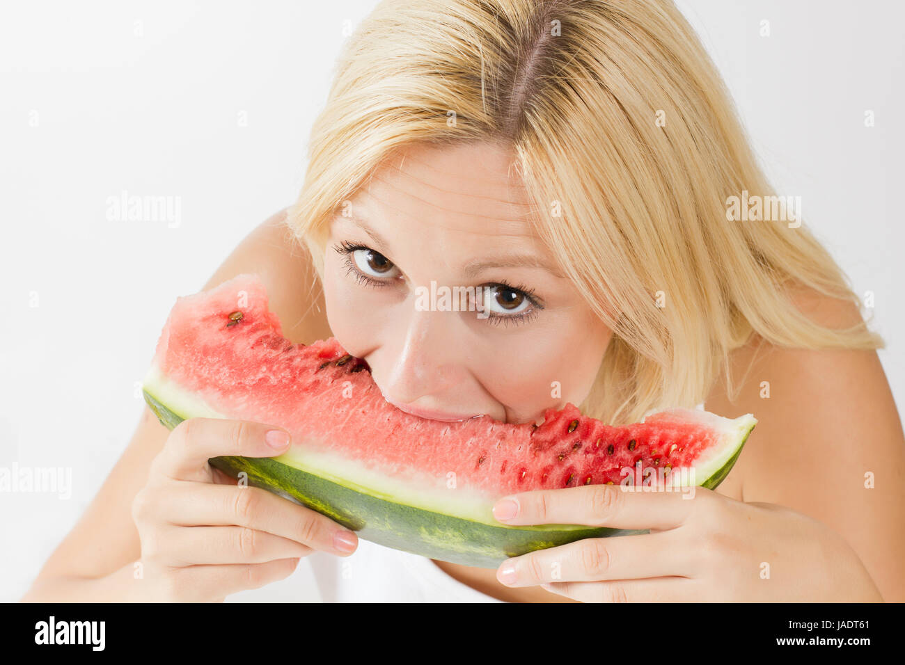 Happy young woman eating fresh watermelon Stock Photo - Alamy