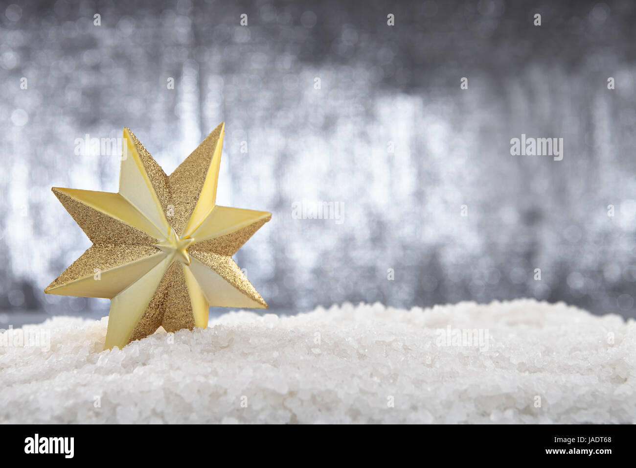 Single Christmas star on snow with silver glittering background Stock ...