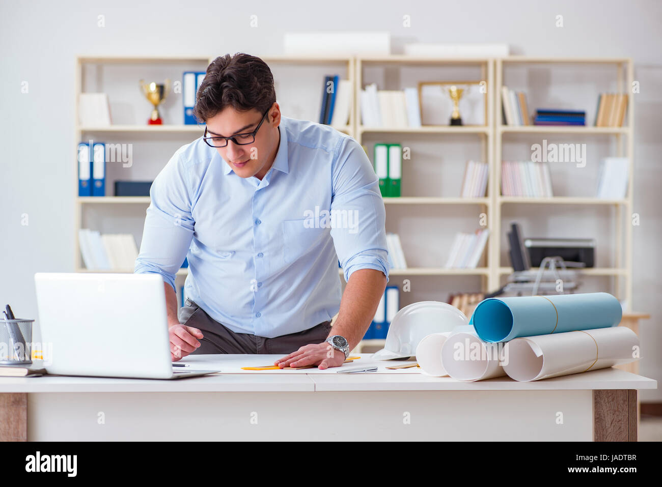 Male engineer working on drawings and blueprints Stock Photo - Alamy