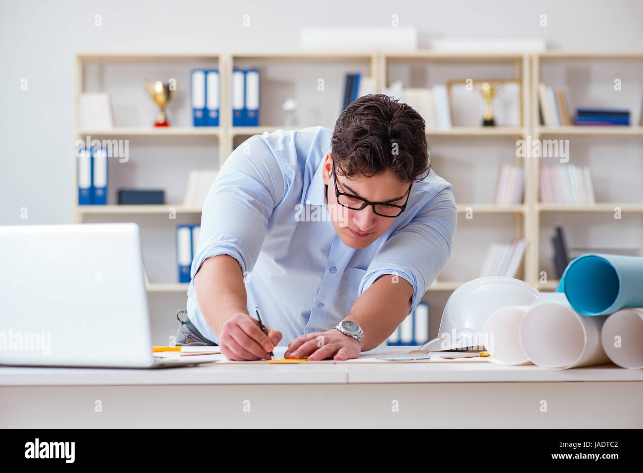 Male engineer working on drawings and blueprints Stock Photo - Alamy