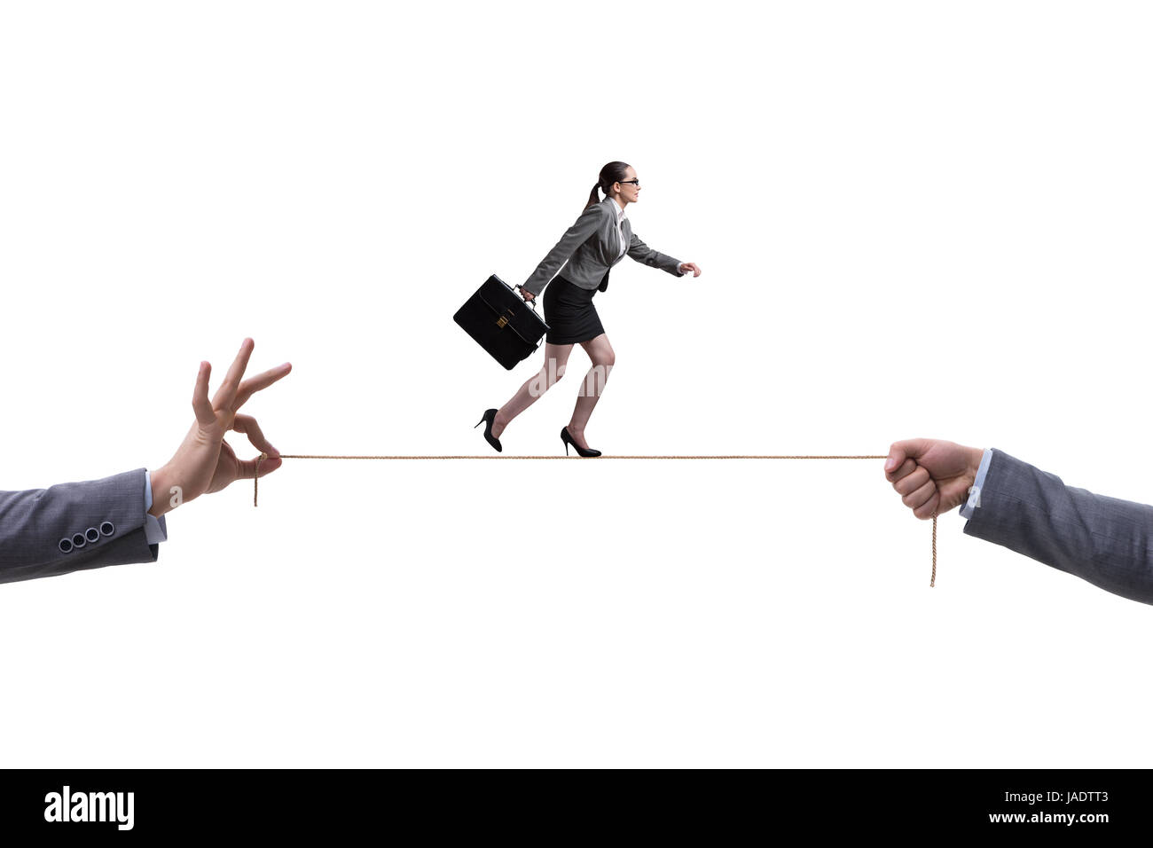 Businesswoman walking on tight rope in business concept Stock Photo - Alamy