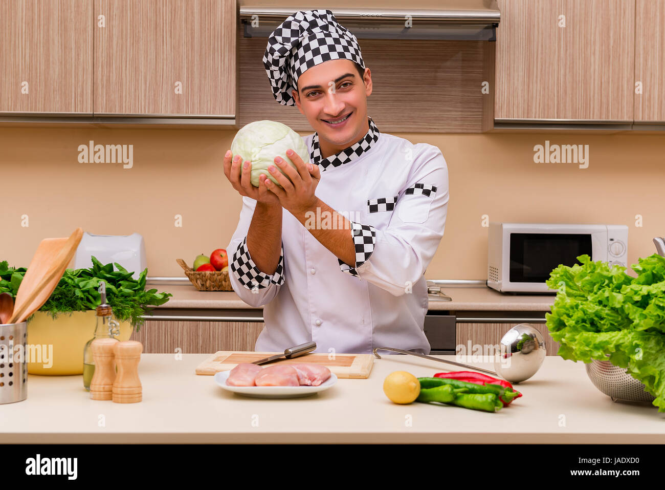 Young chef working in the kitchen Stock Photo - Alamy