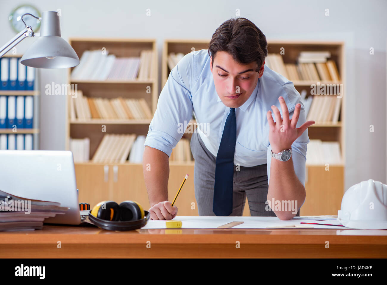 Engineer supervisor working on drawings in the office Stock Photo - Alamy
