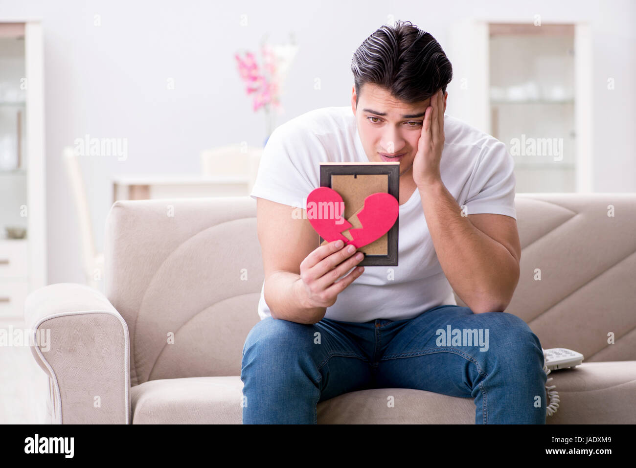Young man in sad saint valentine concept Stock Photo - Alamy
