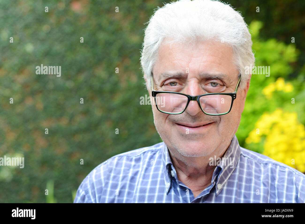 Portrait of an old man sitting outside. Outdoors Stock Photo - Alamy