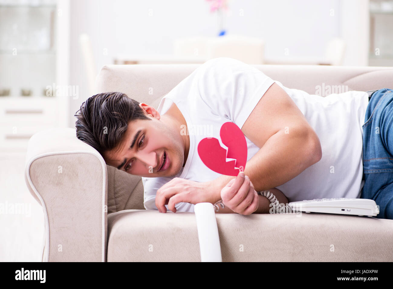 Young man in sad saint valentine concept Stock Photo - Alamy