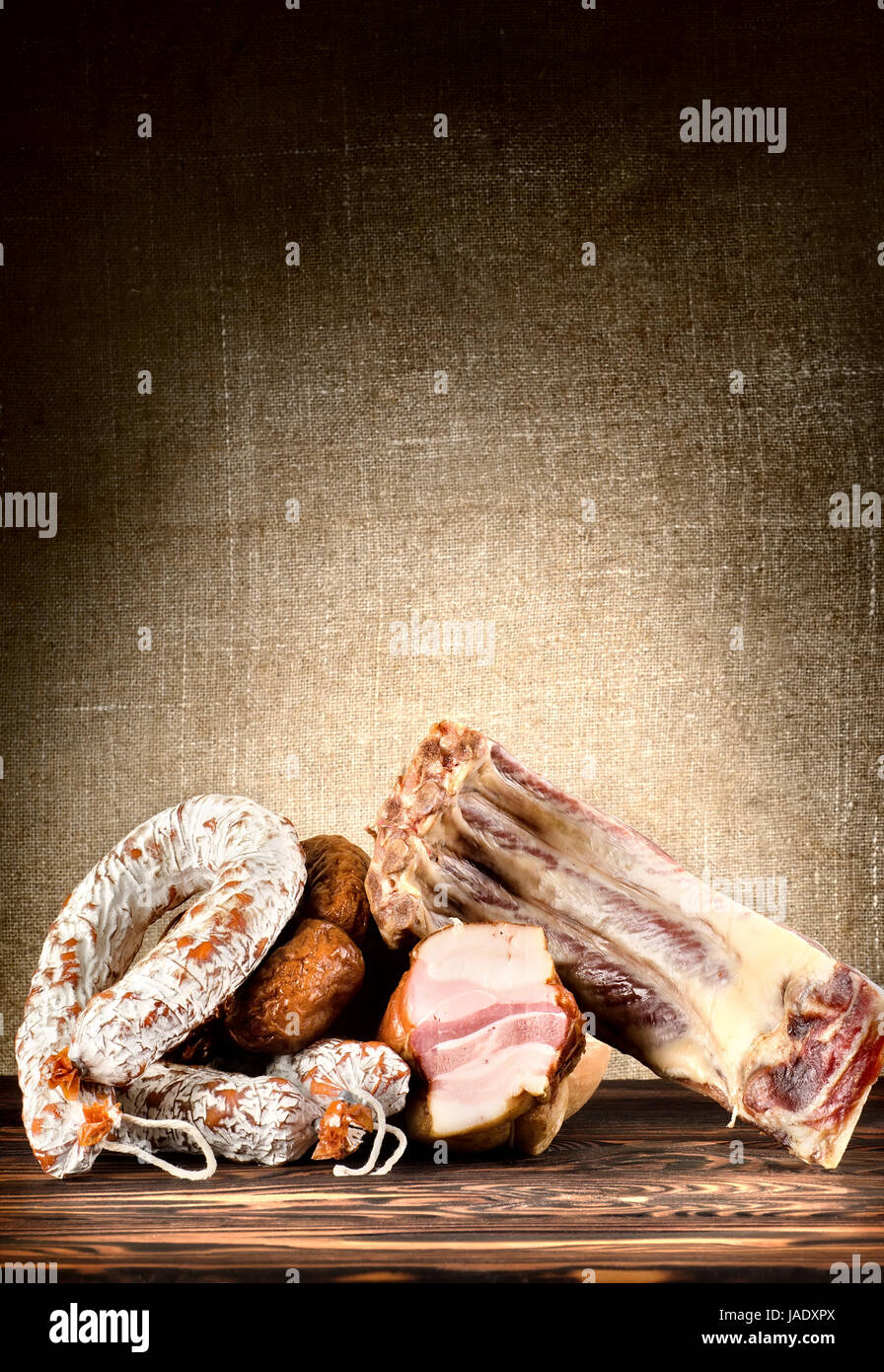 Cooked meat and sausages on the old background Stock Photo - Alamy