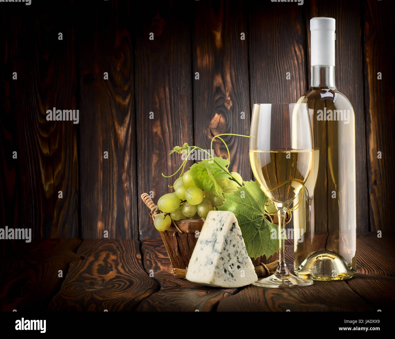 White wine with grapes and blue cheese on a wooden background Stock ...