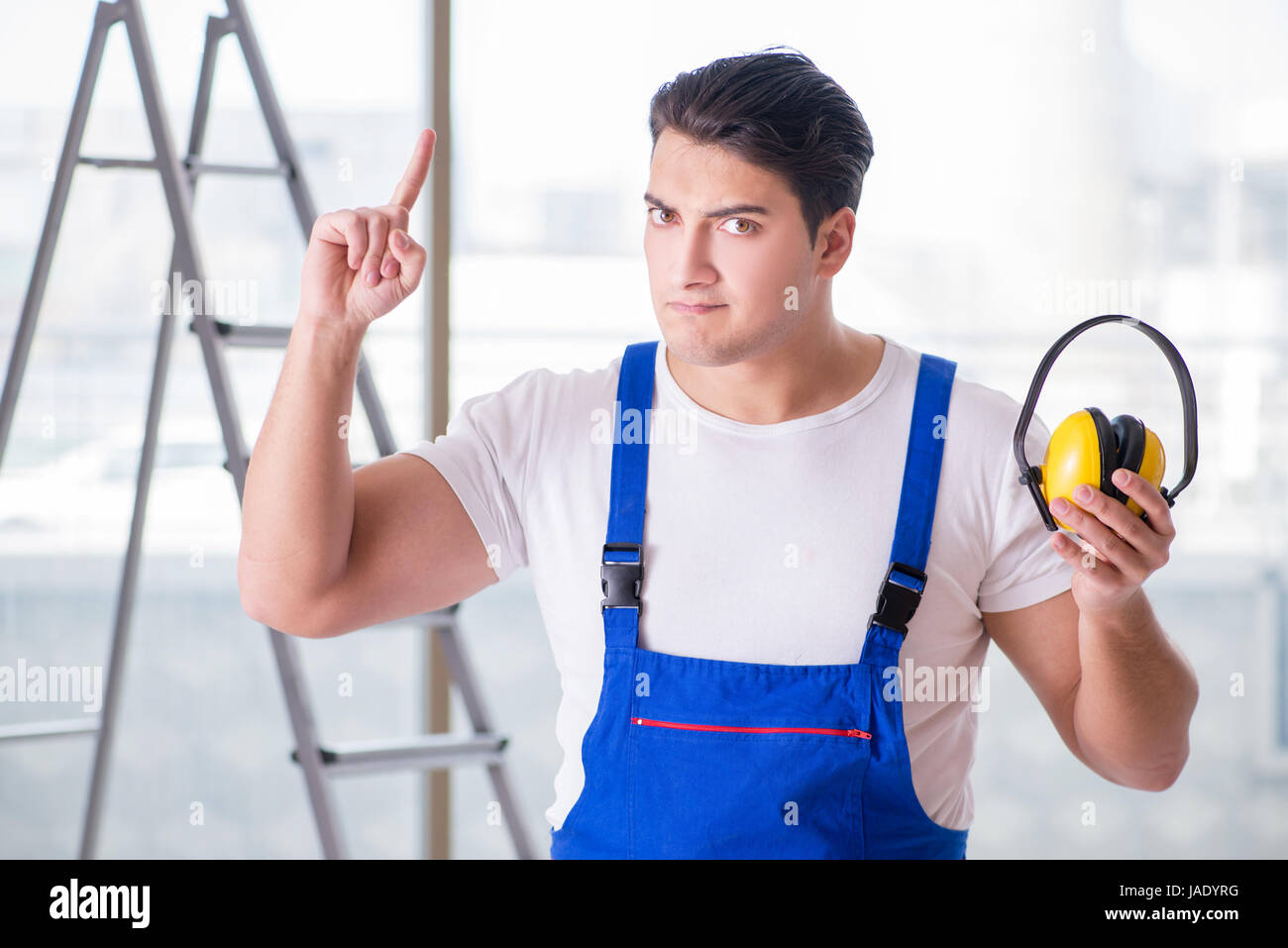 Worker with noise cancelling headphones Stock Photo - Alamy