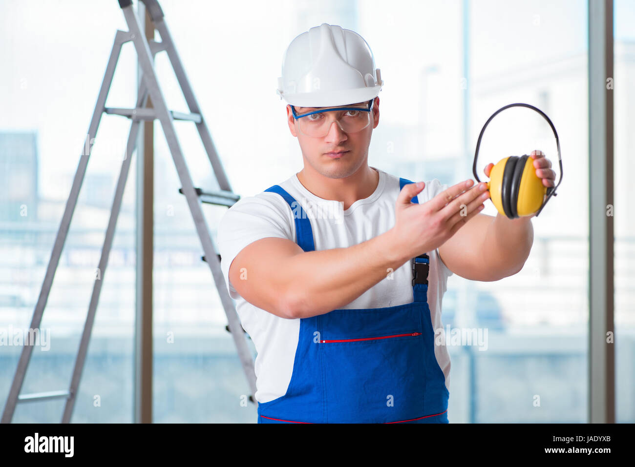 Young worker with noise cancelling headphones Stock Photo - Alamy