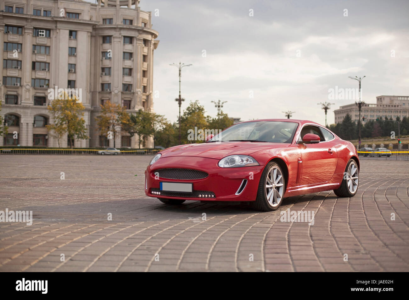 Red luxury sports car in the city Stock Photo - Alamy