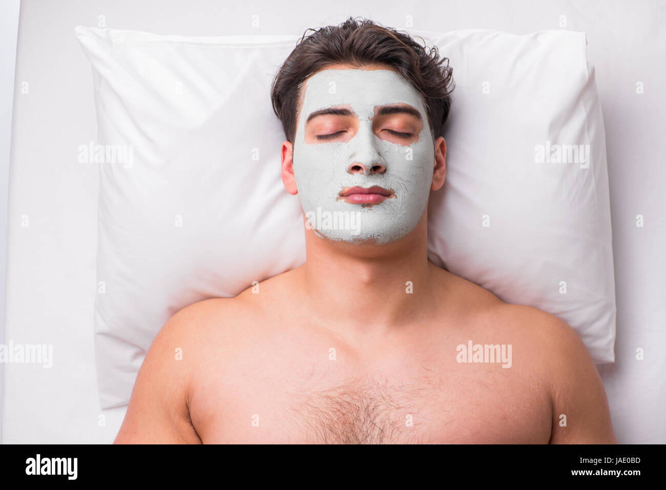Handsome man in spa massage concept Stock Photo - Alamy