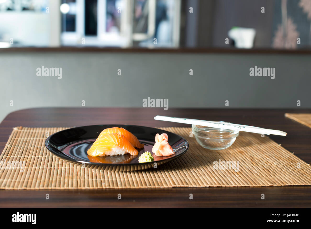Sushi in sushi bar. Table and ration sushi with salmon Stock Photo - Alamy