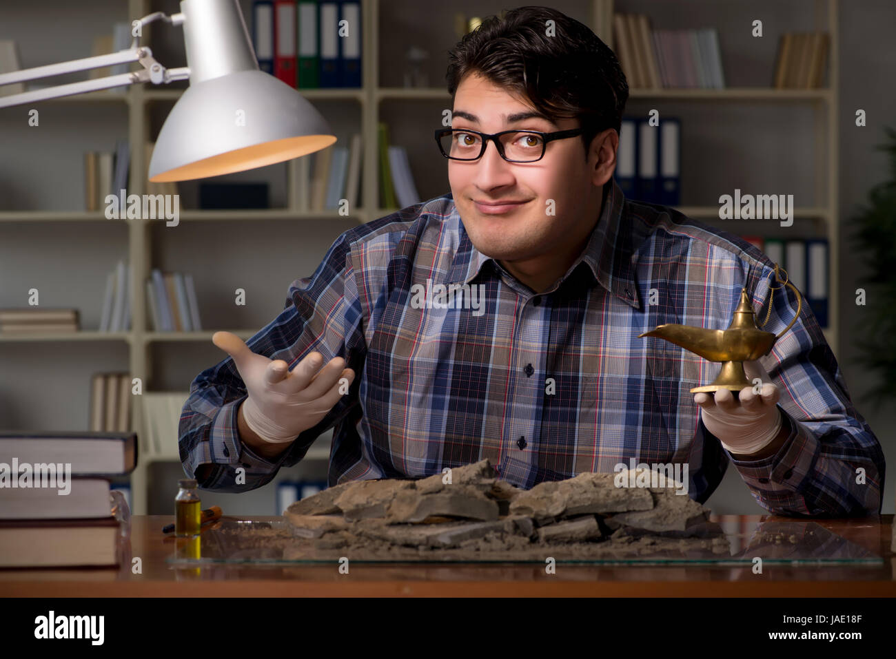 Archeologist working late night in office Stock Photo - Alamy