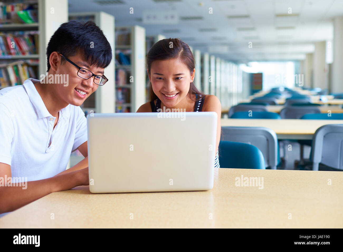 Happy young Chinese or Asian college students study together in the ...