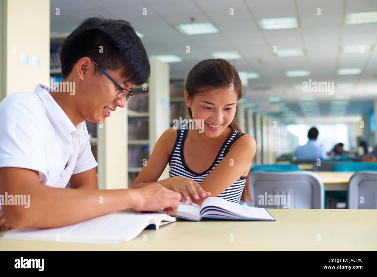 Young asian or Chinese college students study together in the library ...