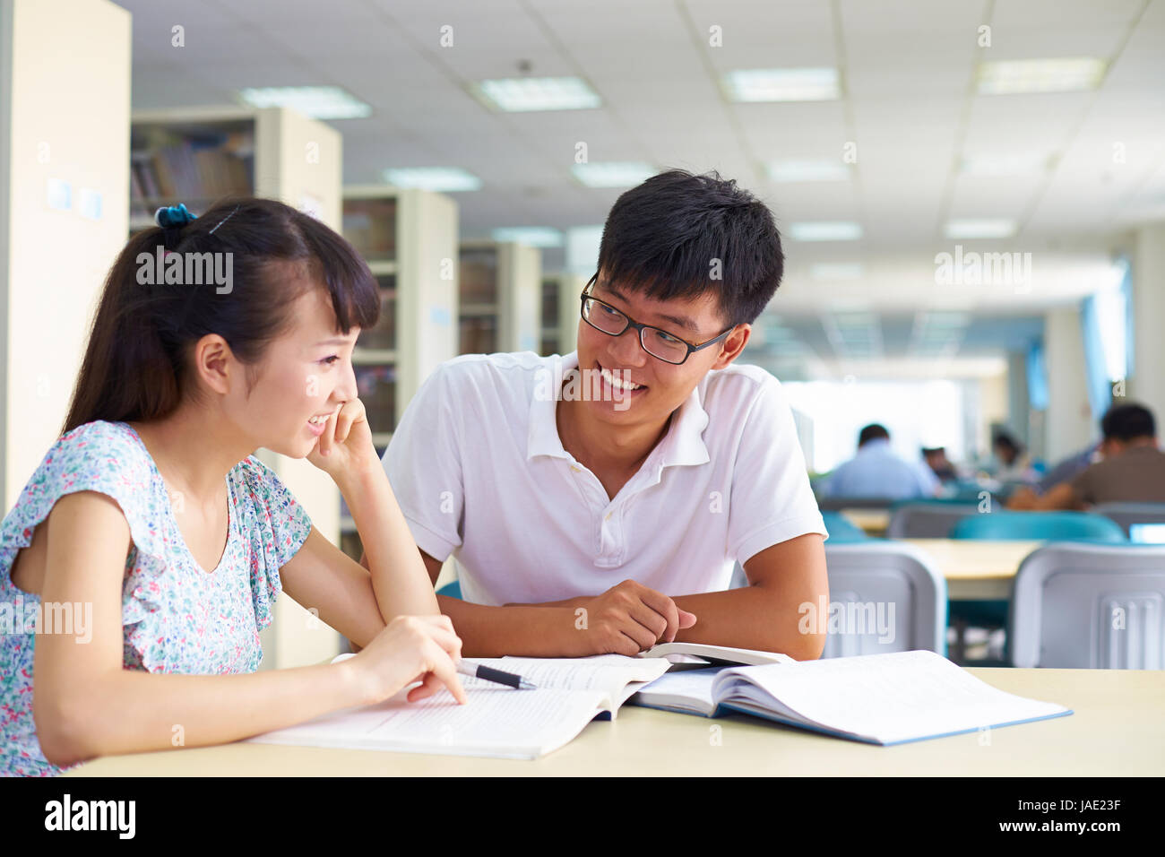 Young asian or Chinese college students study together in the library ...