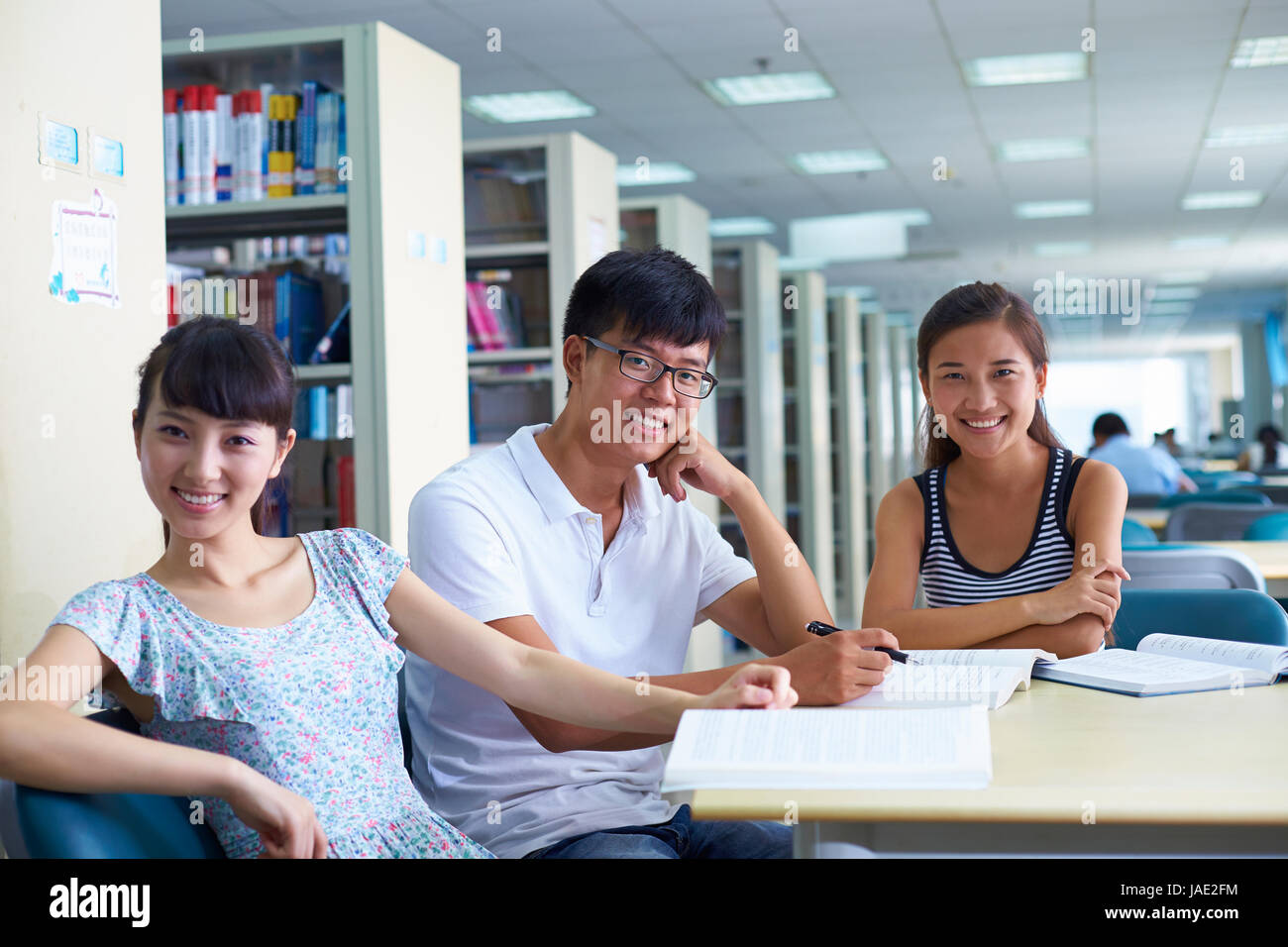 Young asian or Chinese college students study together in the library ...