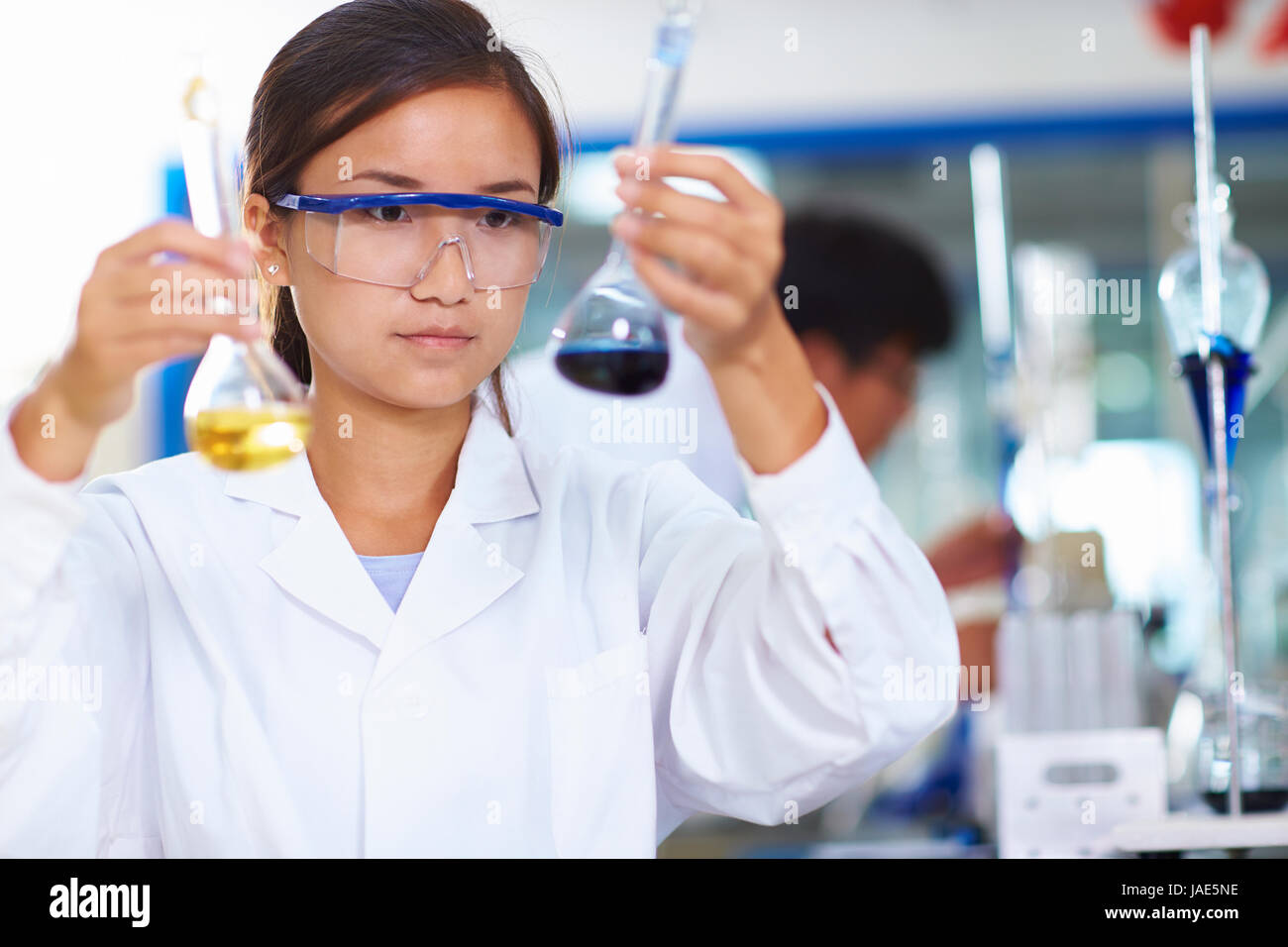 One Female Chinese Laboratory scientist working at lab with test tubes ...