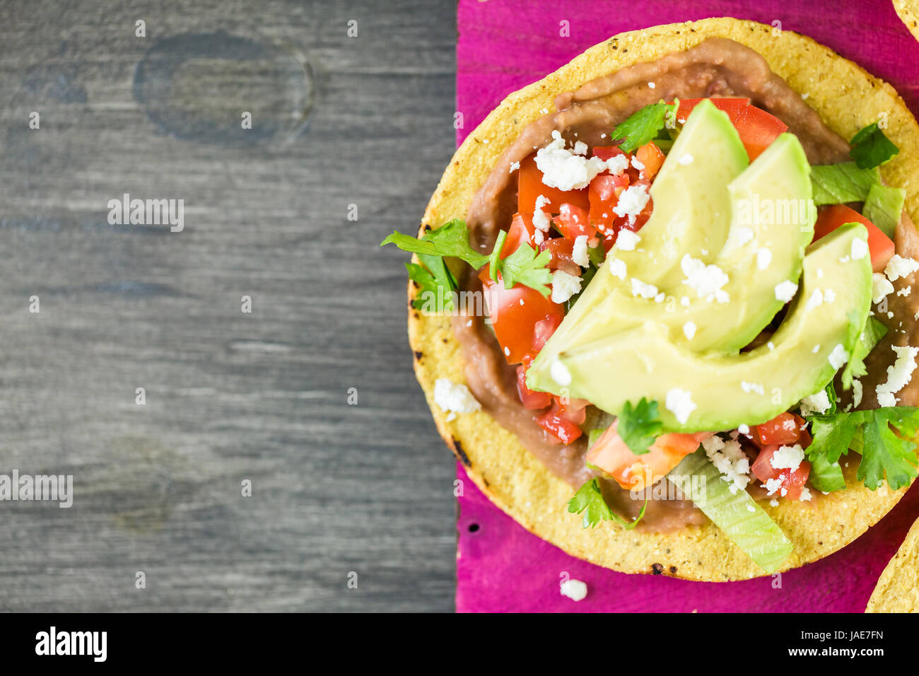 Fresh vegeterian Mexican tostadas on purple cutting board Stock Photo ...