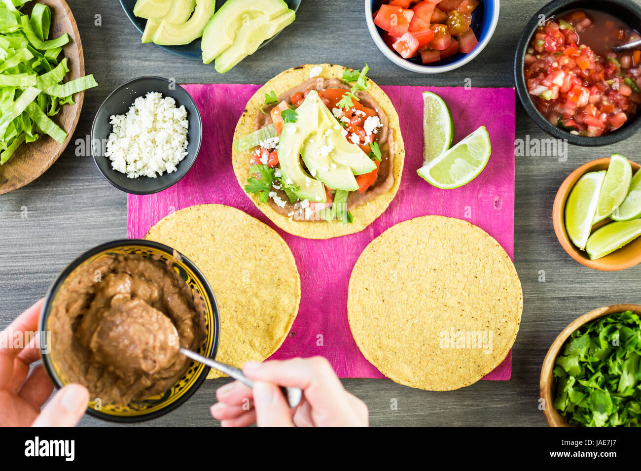 Step by step. Fresh vegeterian Mexican tostadas on purple cutting board ...