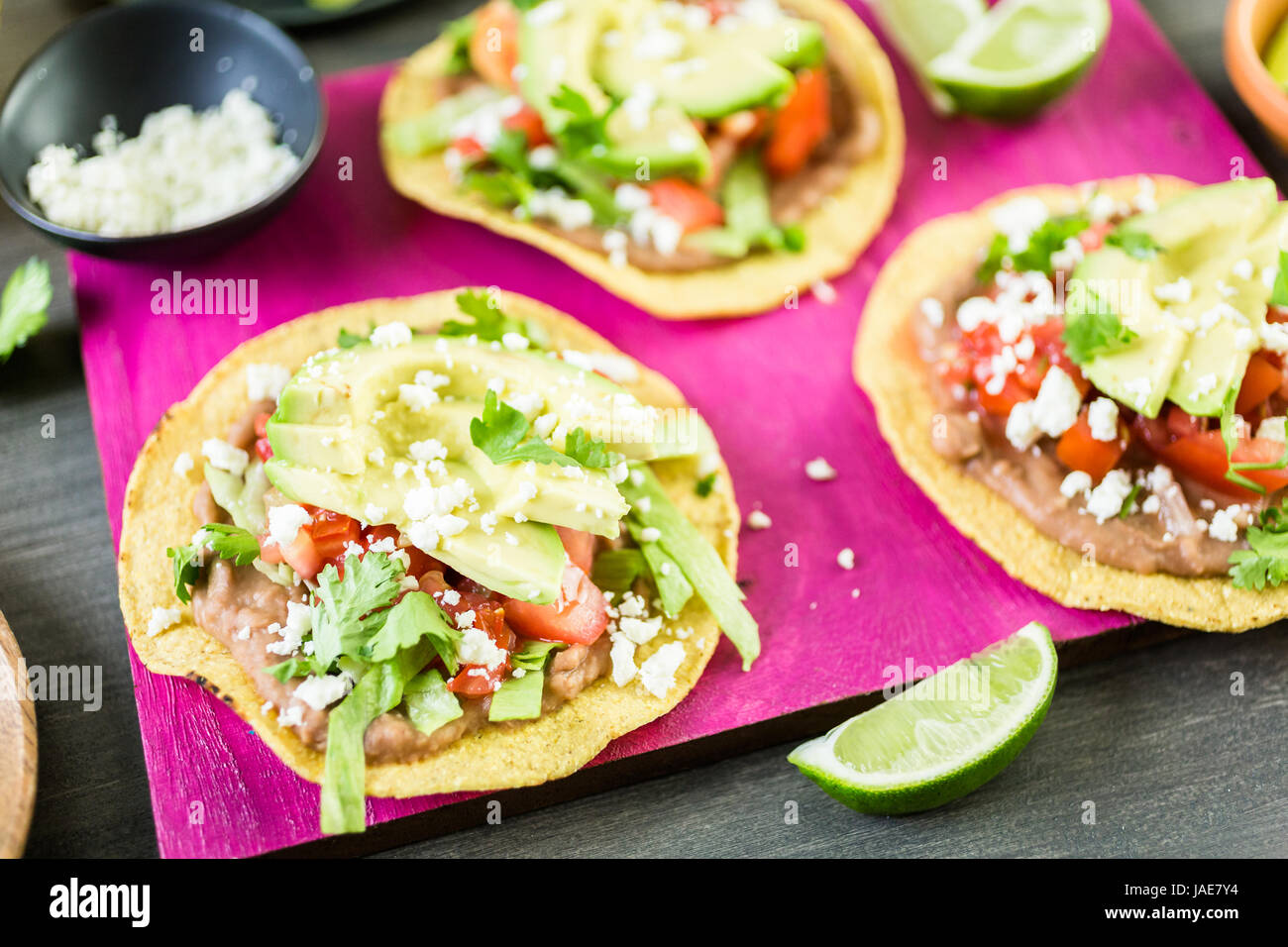 Fresh vegeterian Mexican tostadas on purple cutting board Stock Photo ...