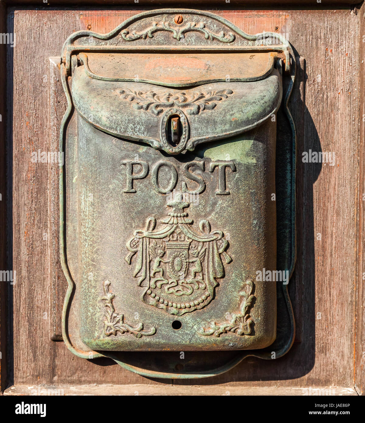 picture of an antique letter box at a wooden door Stock Photo - Alamy