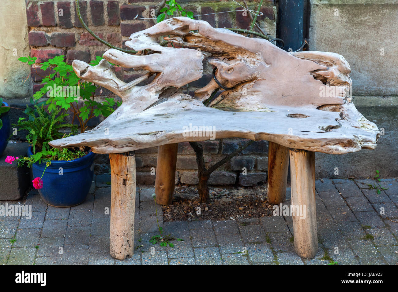 picture of a rustic wooden bench in front of a house Stock Photo - Alamy