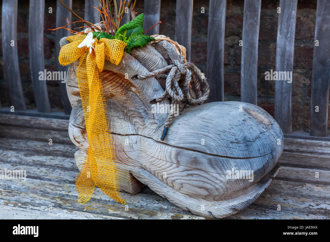 picture of a clog as decoration on a wooden bench Stock Photo - Alamy