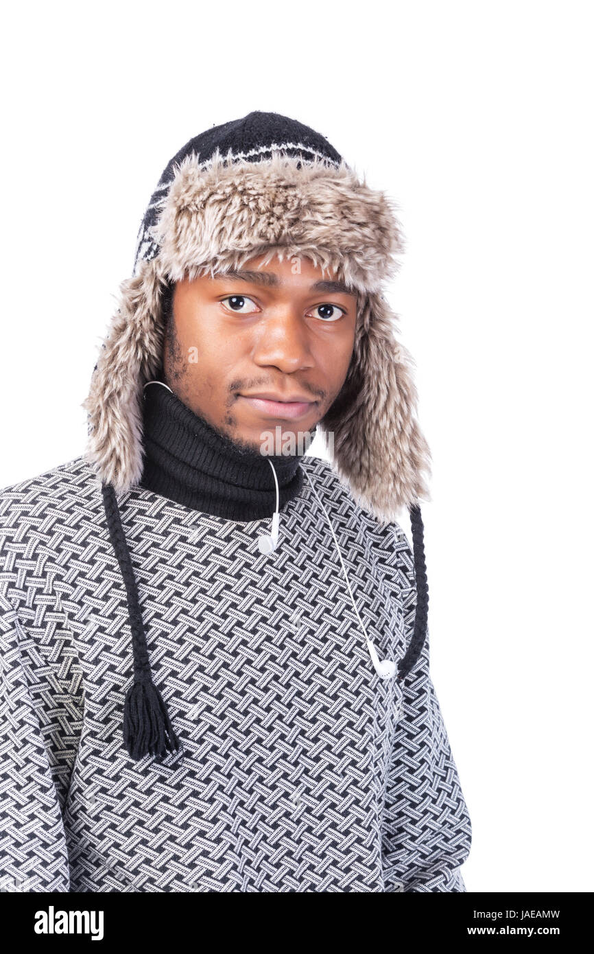Young African-American wearing winter clothing but feeling cold in a ...