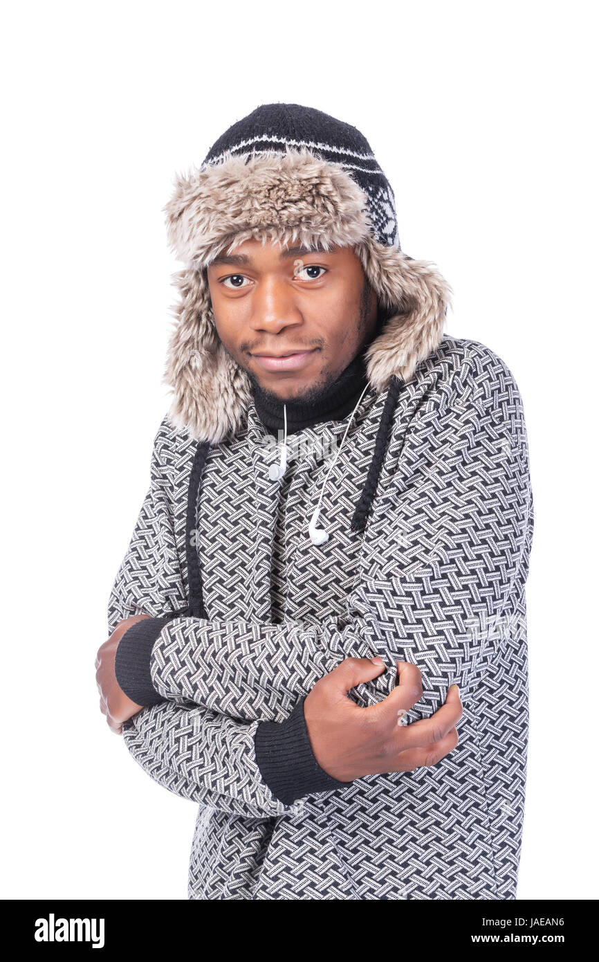 Young African-American wearing winter clothing but feeling cold in a ...