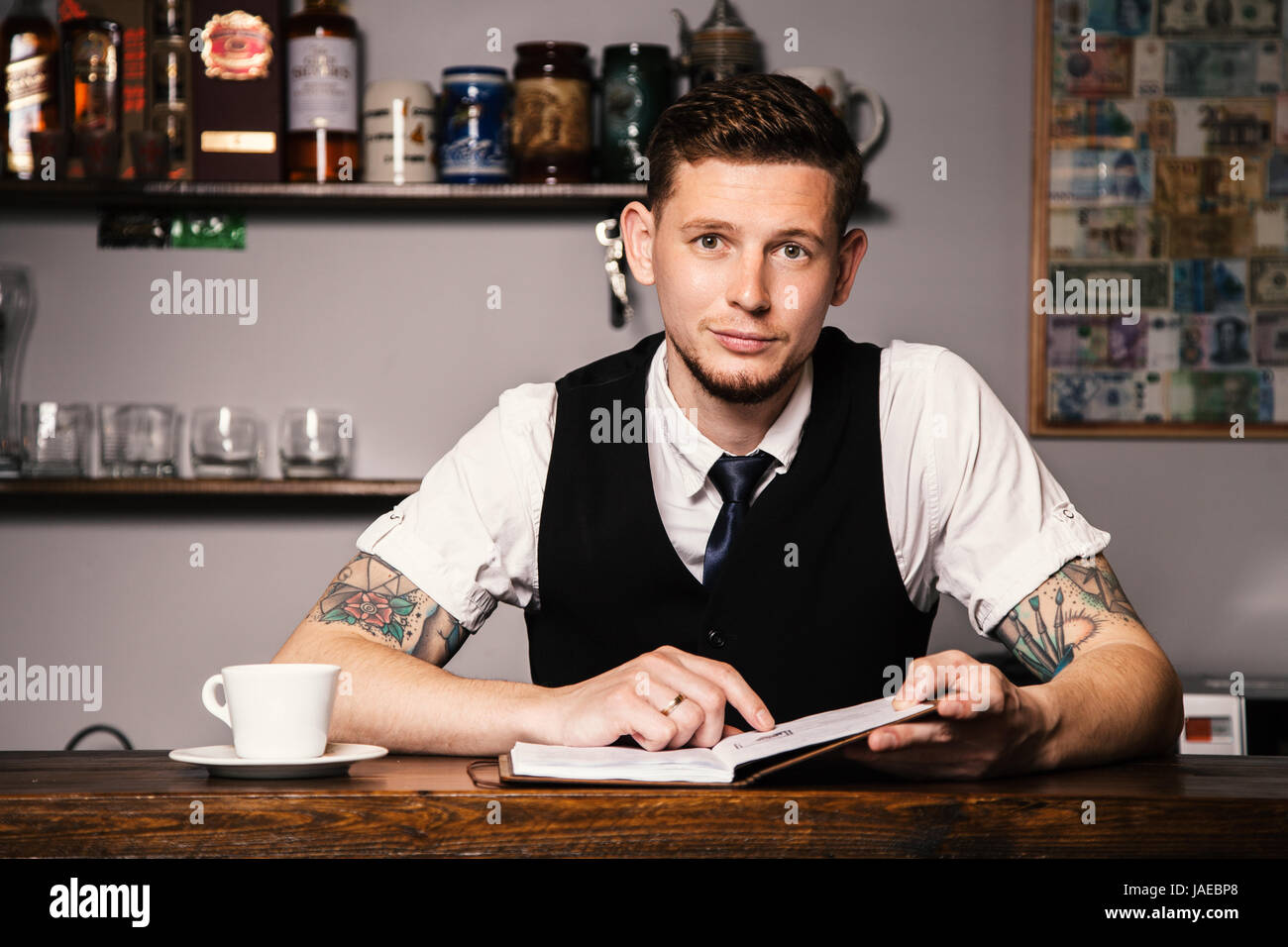 Professional barber in a barbershop at reception Stock Photo - Alamy