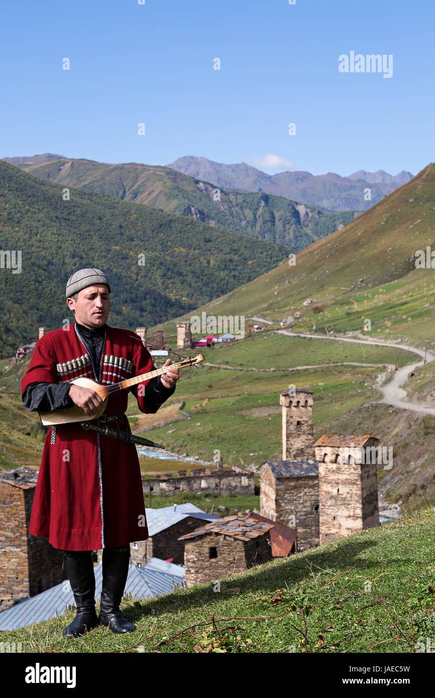 Georgian man in national costumes playing the local musical instrument ...
