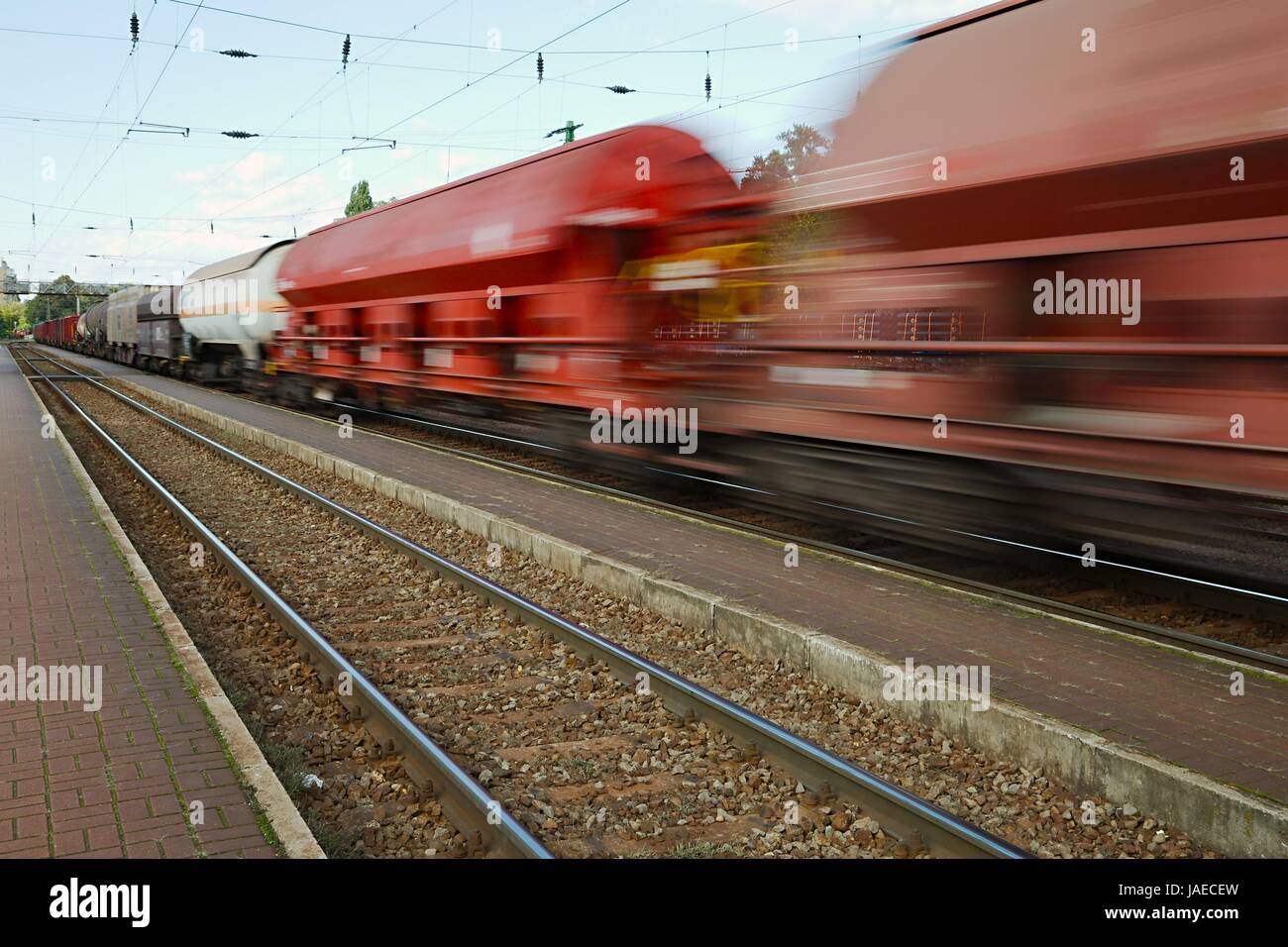 Freight train passing by with blur Stock Photo - Alamy