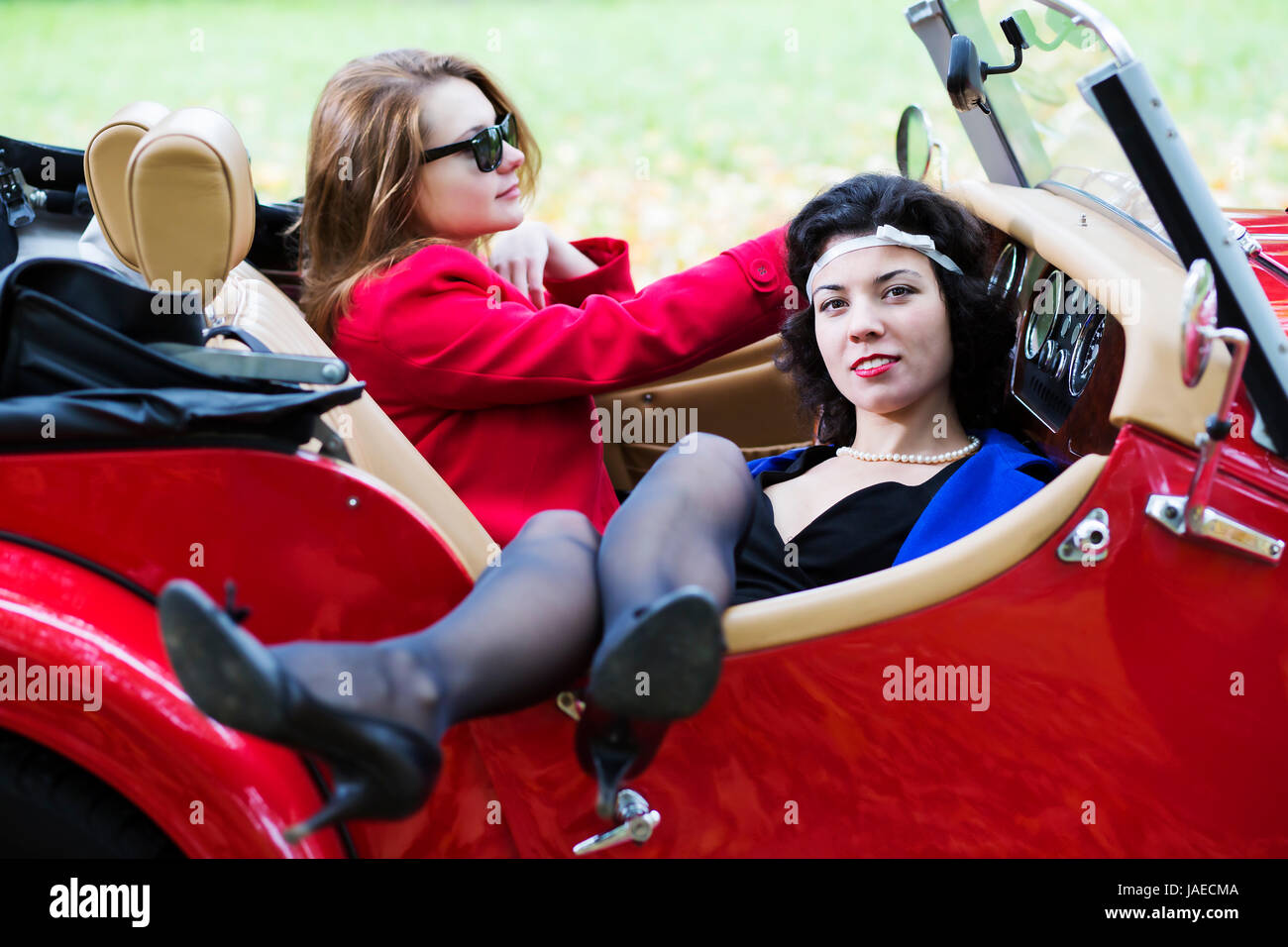 Beautiful women driving red car hi-res stock photography and images - Alamy