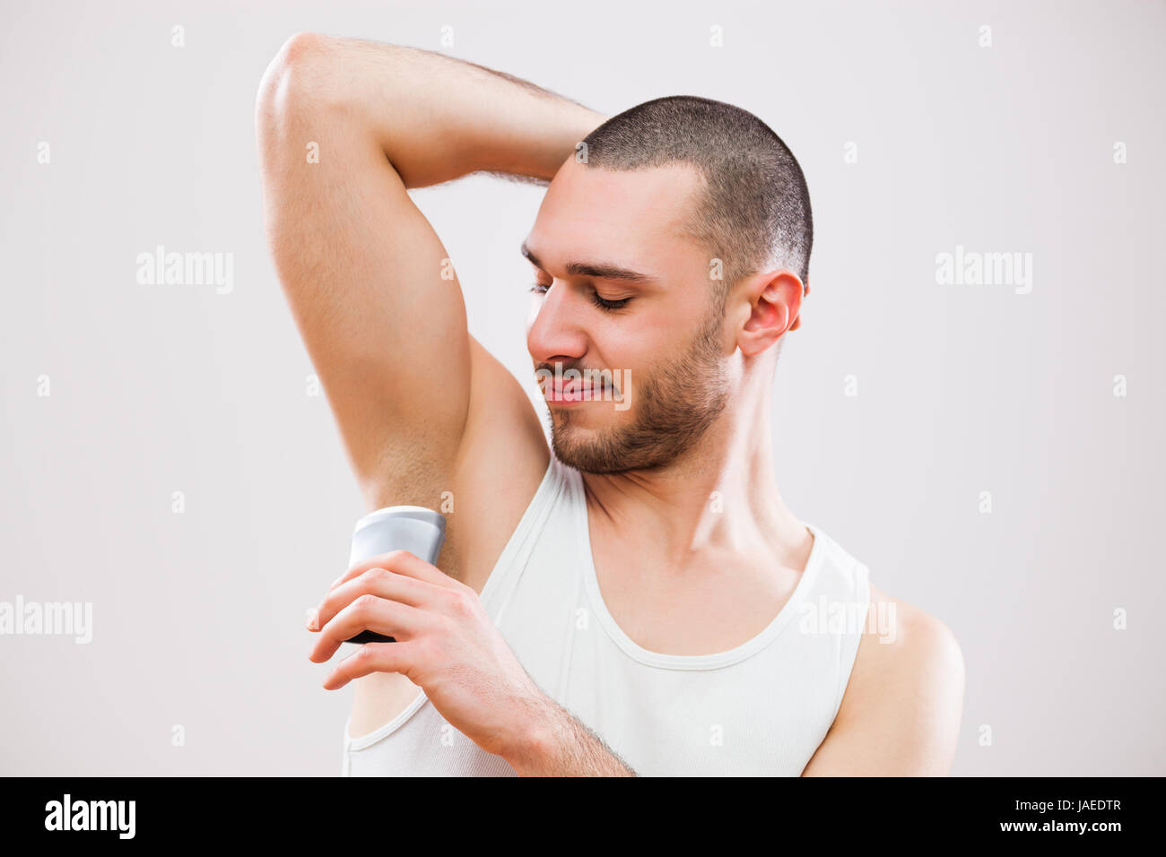 Man Putting On Deodorant