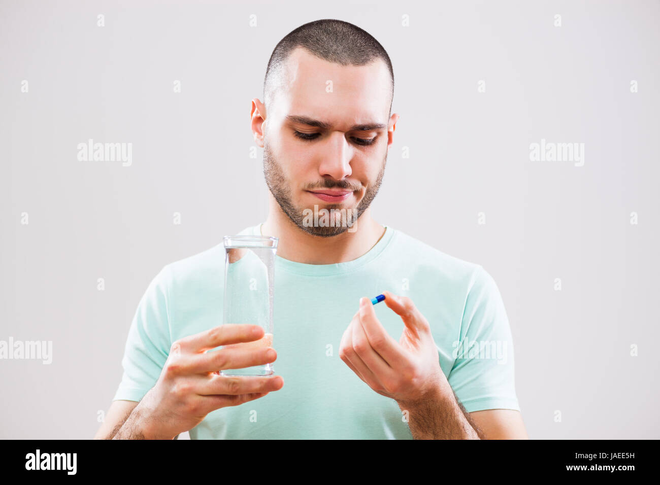 Worried person taking pill hi-res stock photography and images - Alamy