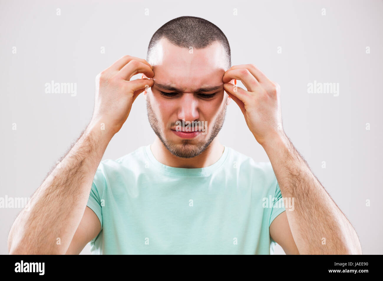 Portrait of young man who is having headache Stock Photo - Alamy