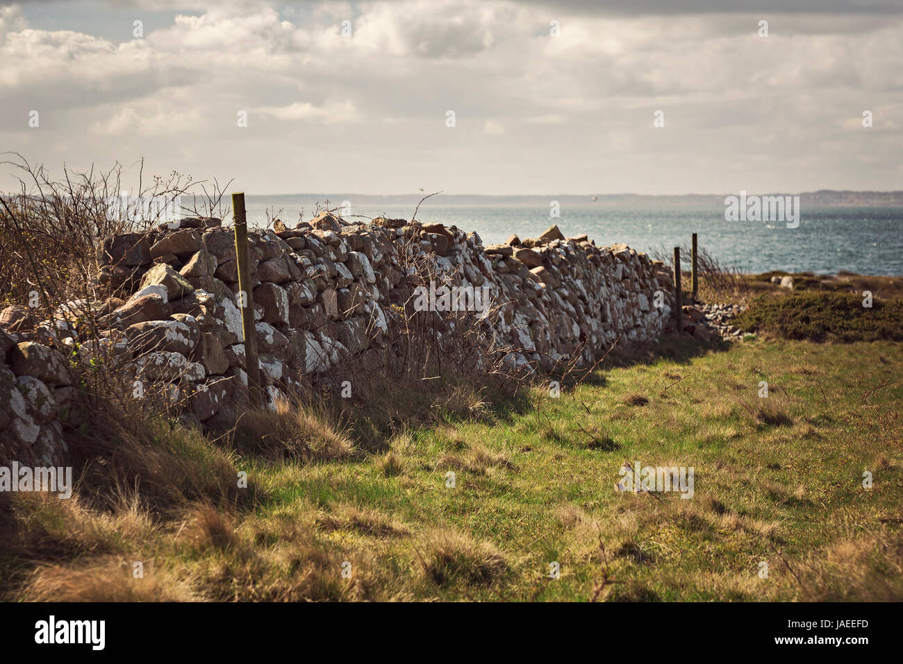 Natural stone wall built by the seaside Stock Photo - Alamy