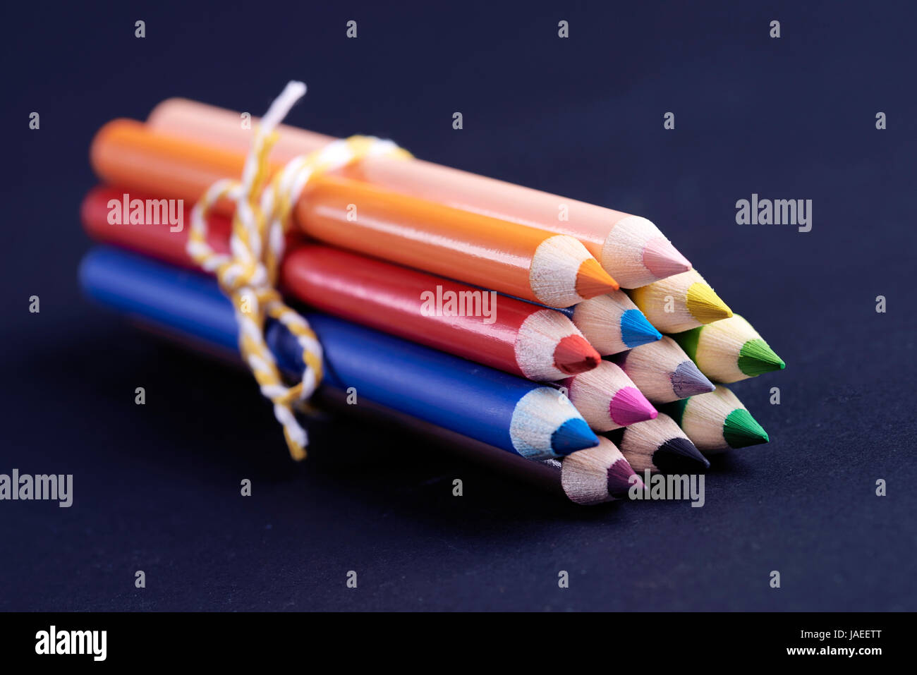 Colored pencils tied up with ribbon Stock Photo - Alamy